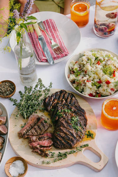 Outdoor Summer Grilling Party with cooked red meats and salad served on ...